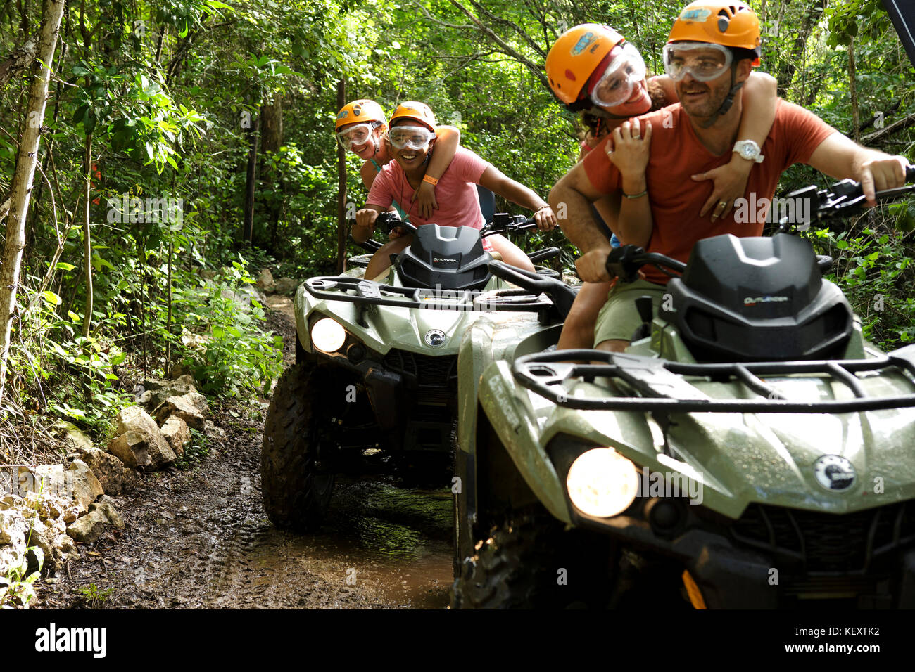 Couples embracing while riding quad bikes in Emotions Native Park ...