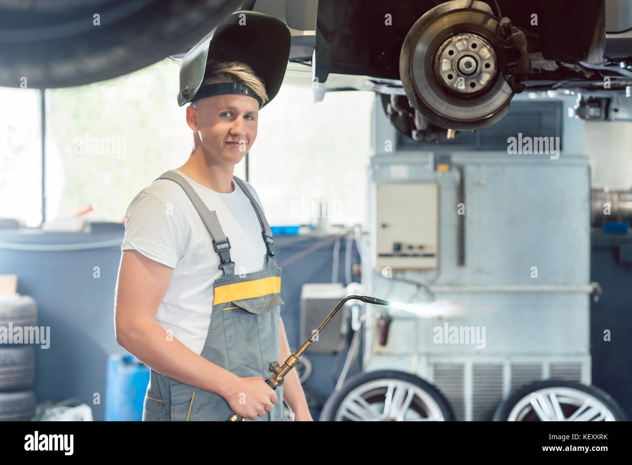 Portrait of a handsome auto mechanic looking at camera with conf Stock ...