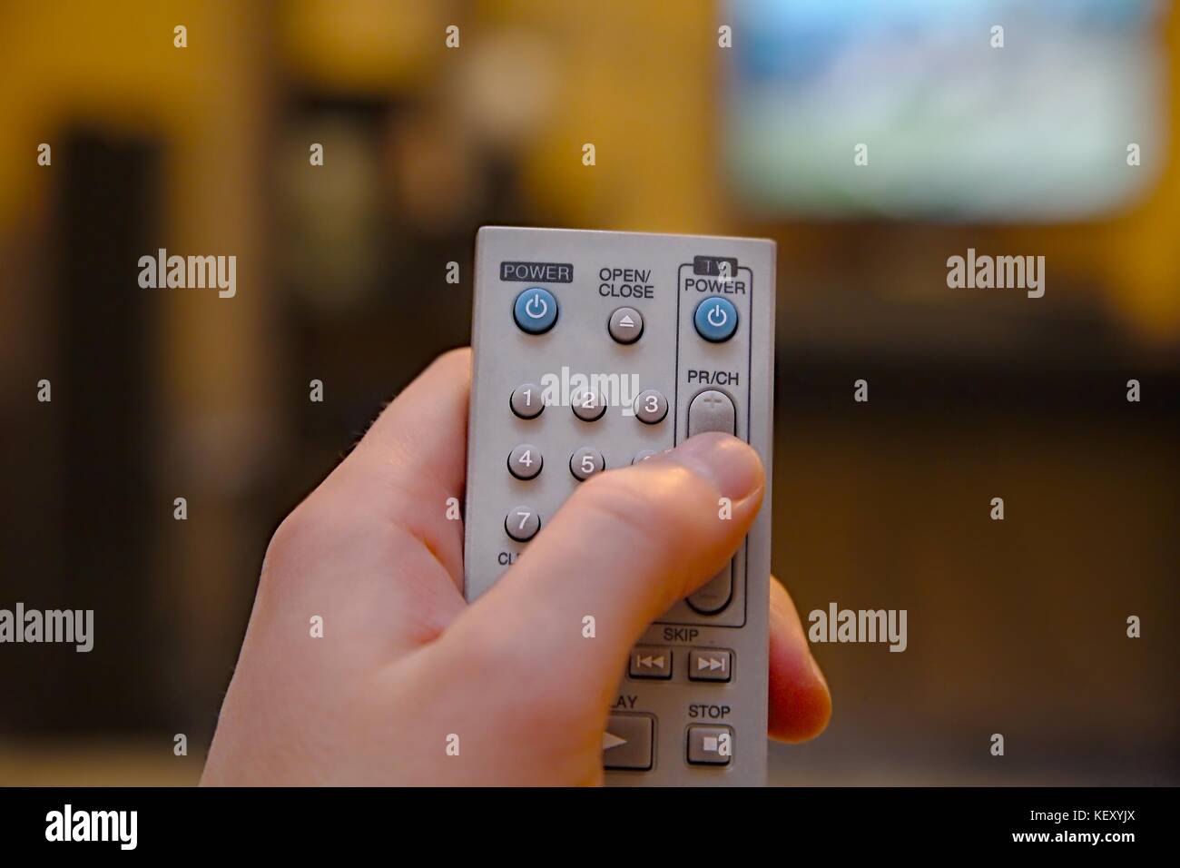Using remote control for switching programs Stock Photo - Alamy