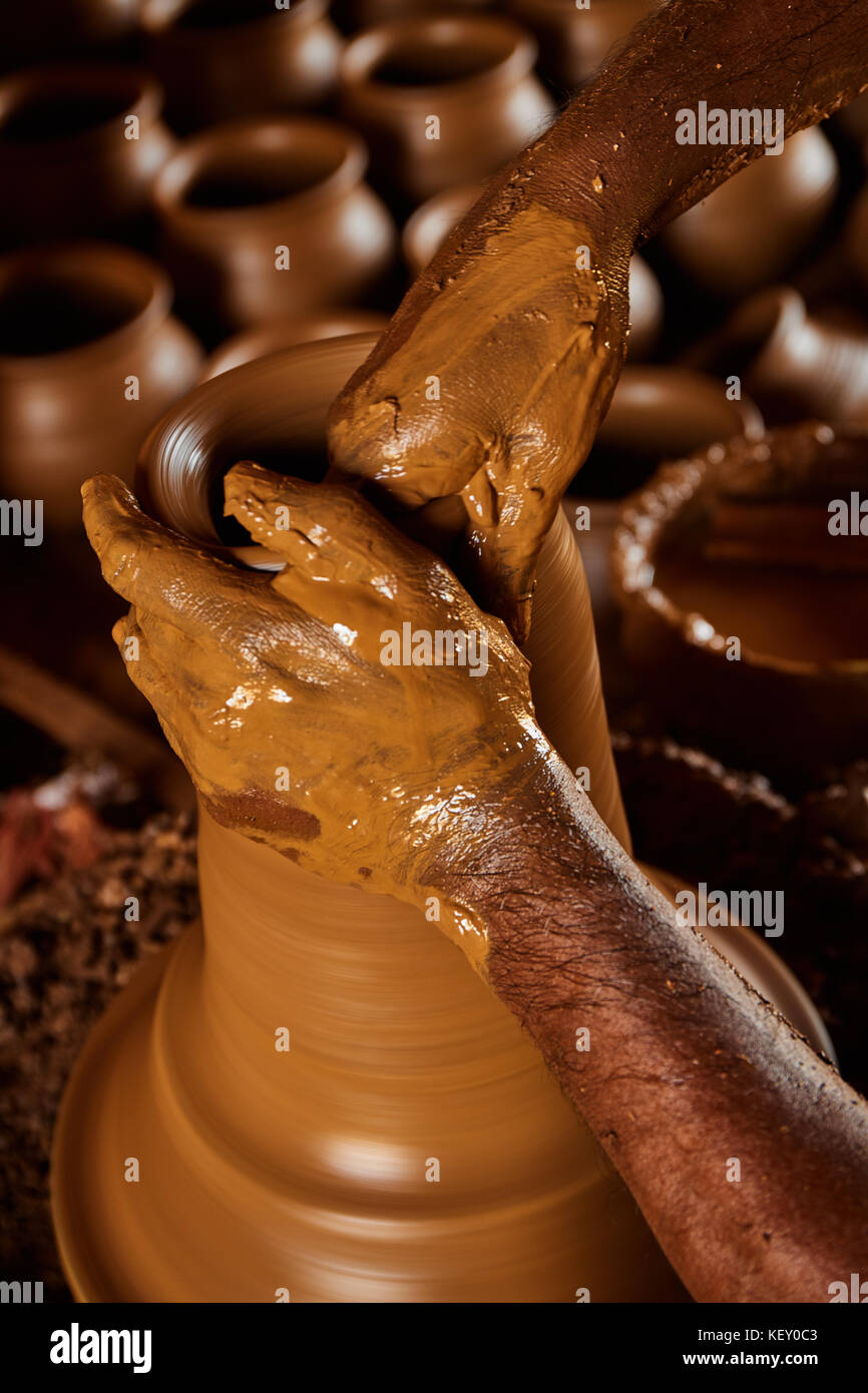 Hands of making clay pot on the pottery wheel ,select focus, close-up ...