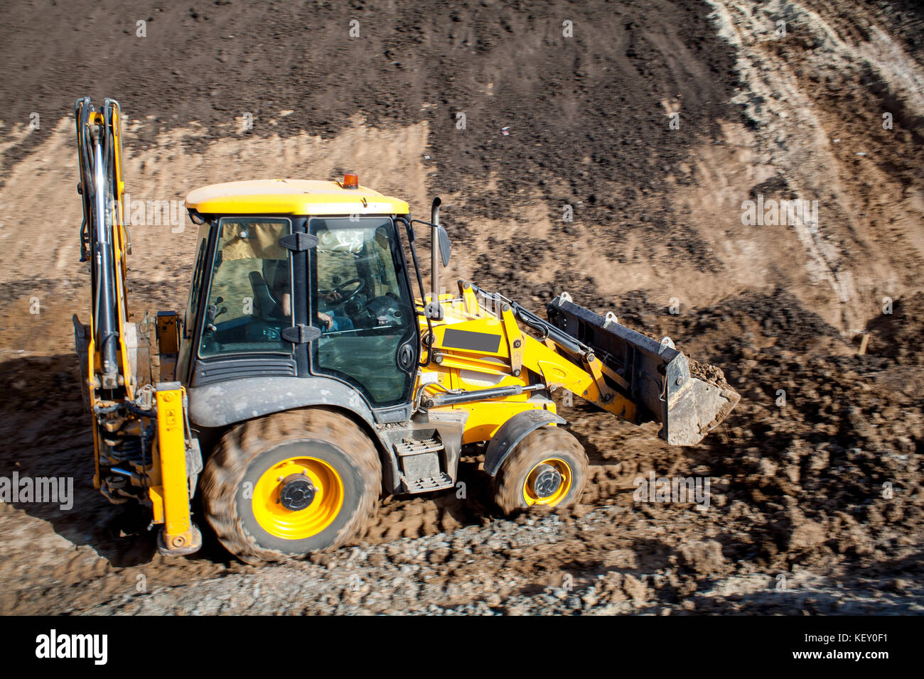 Tractor loader backhoe digger loader on a construction site with blue ...