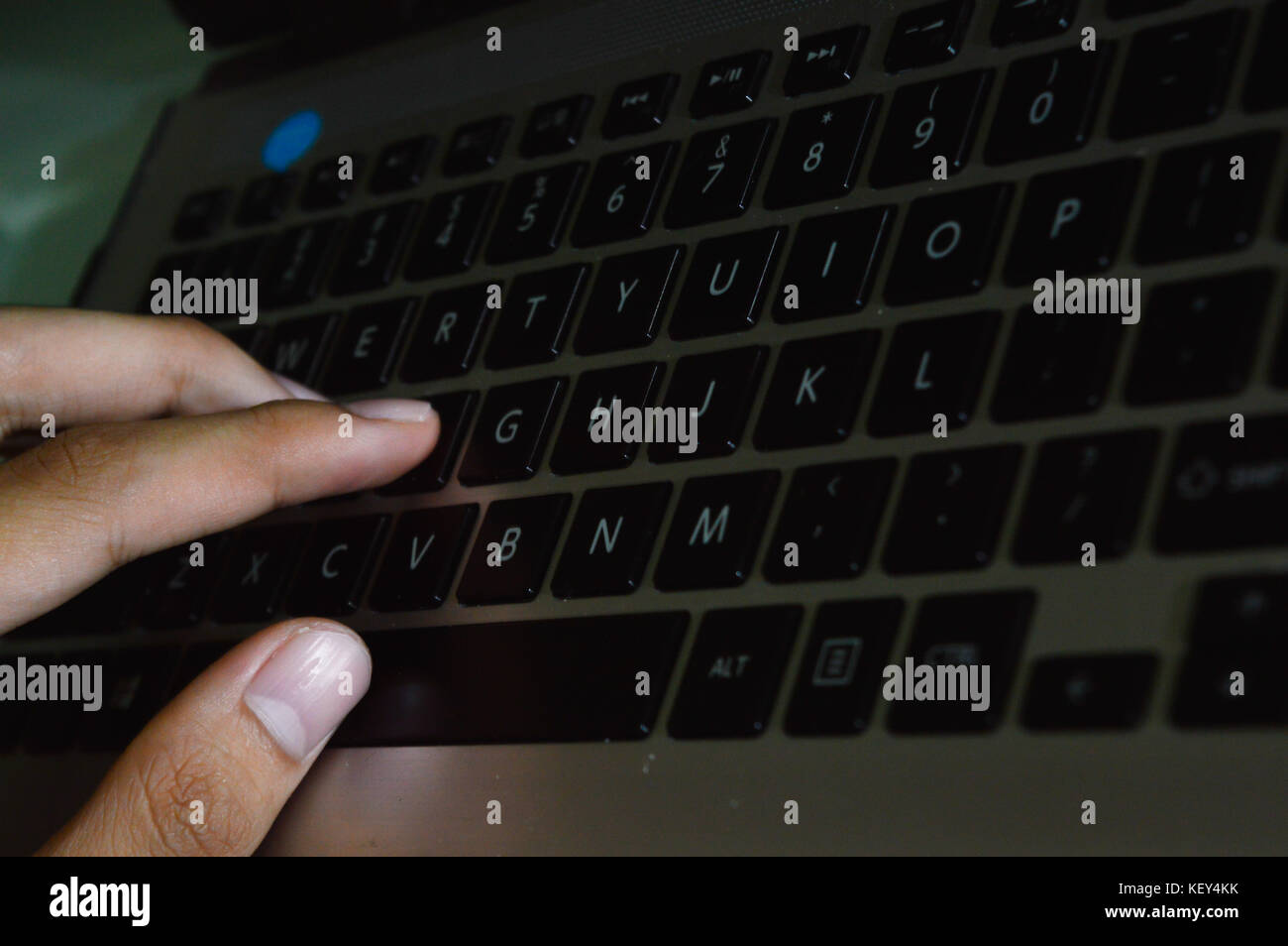 human finger is typing on a keyboard Stock Photo - Alamy