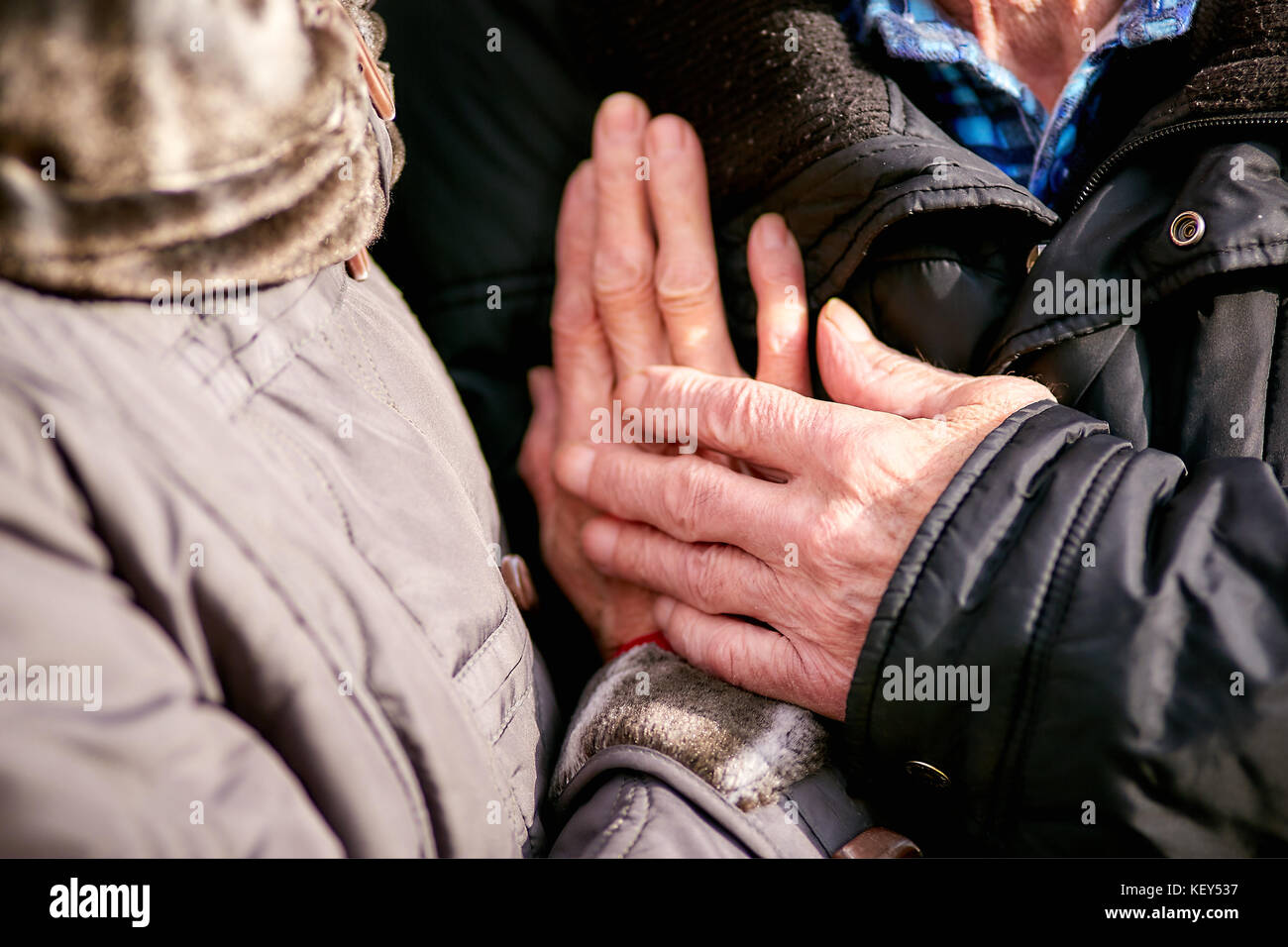 elderly people holding hands Stock Photo - Alamy
