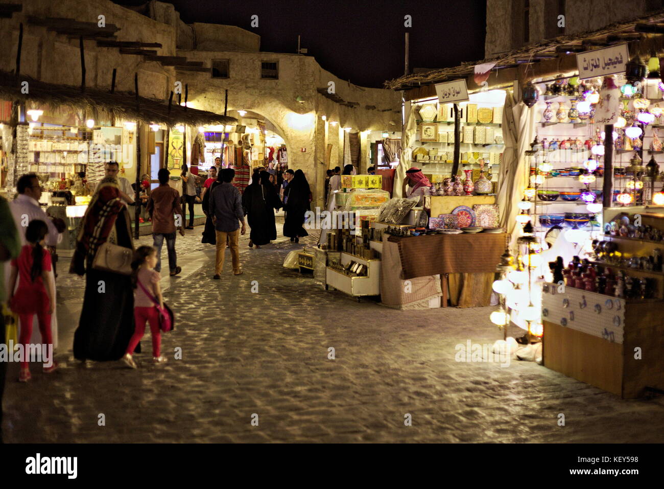 DOHA, QATAR - APRIL 23, 2017: Shoppers in the main thoroughfare of Souq ...