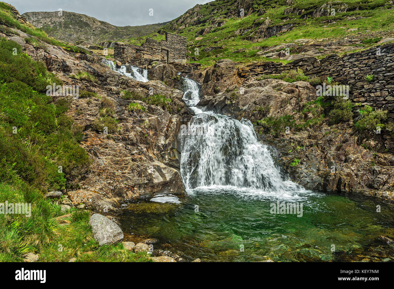 Waterfalls on Afon (River) Cwm Llan and an old slate quarry building ...