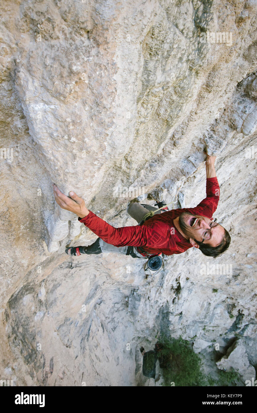View from above of rock climber climbing cliff at Bluefin (5.12b ...
