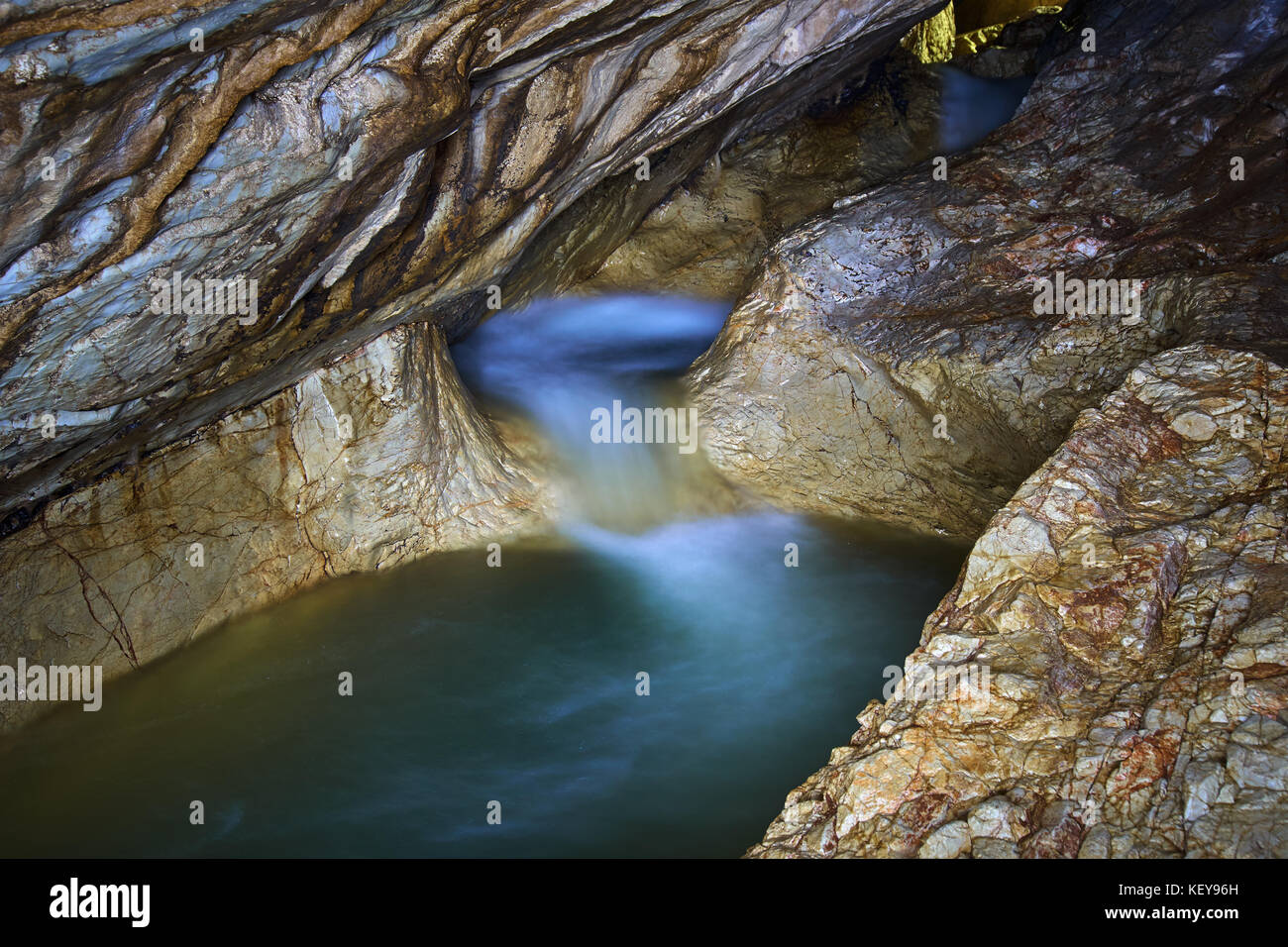 Underground river flowing through a cave in limestone mountains Stock ...