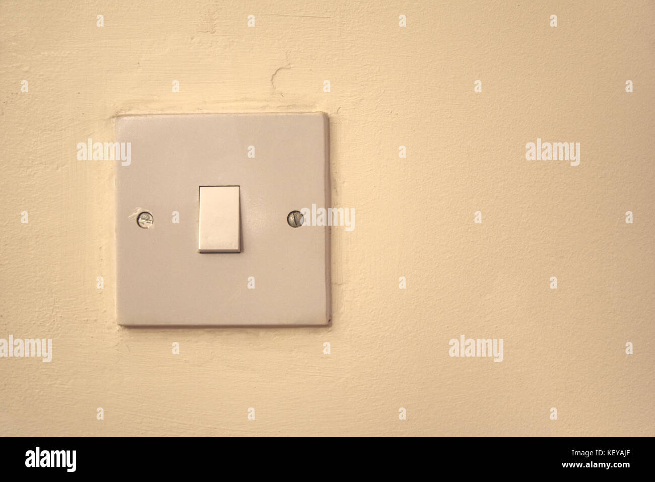 White light switch on interior wall on left hand side of image Stock ...