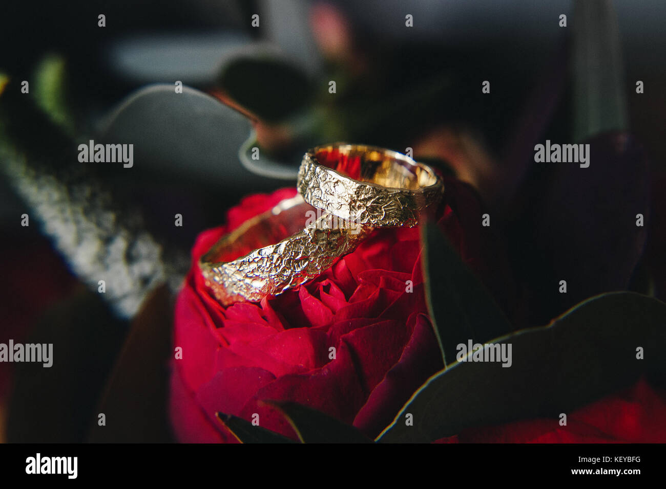Wedding rings on the bouquet of red color. Wedding details Stock Photo ...
