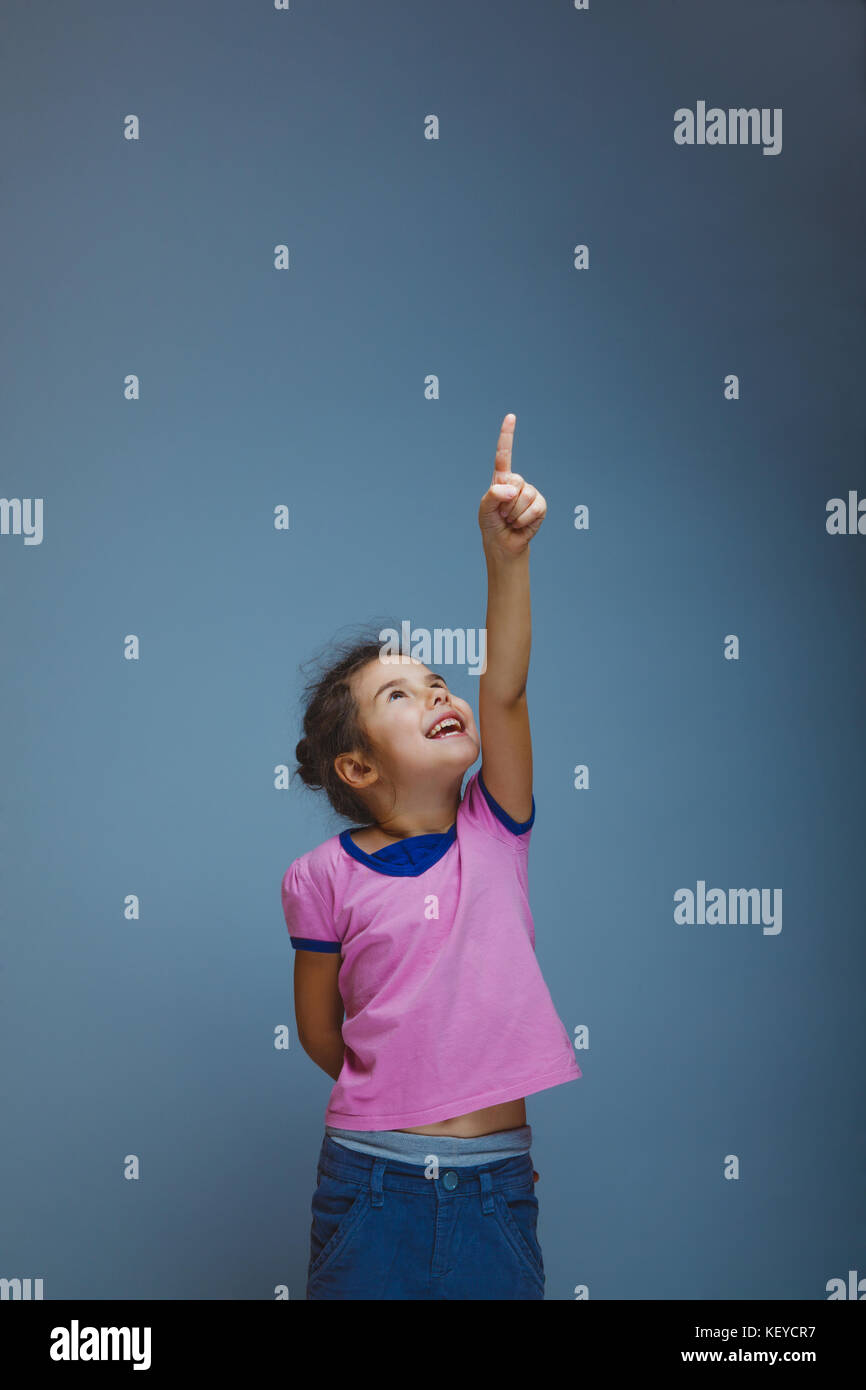 girl child shows finger up on a gray background Stock Photo - Alamy