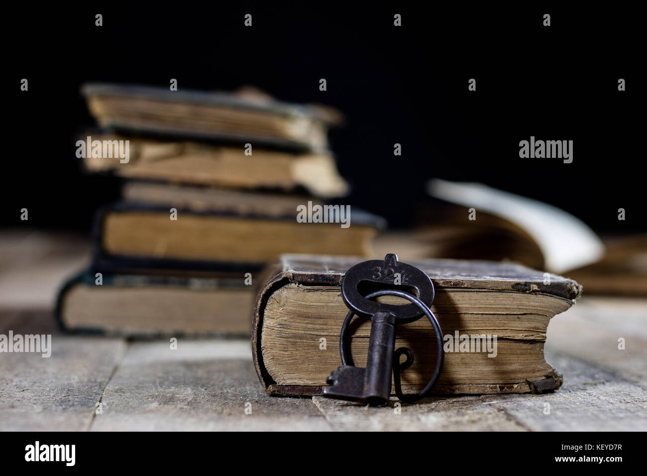 Very old book and key on an old wooden table. Old room, wooden table ...
