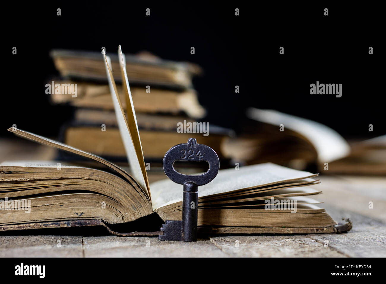 Very old book and key on an old wooden table. Old room, wooden table ...