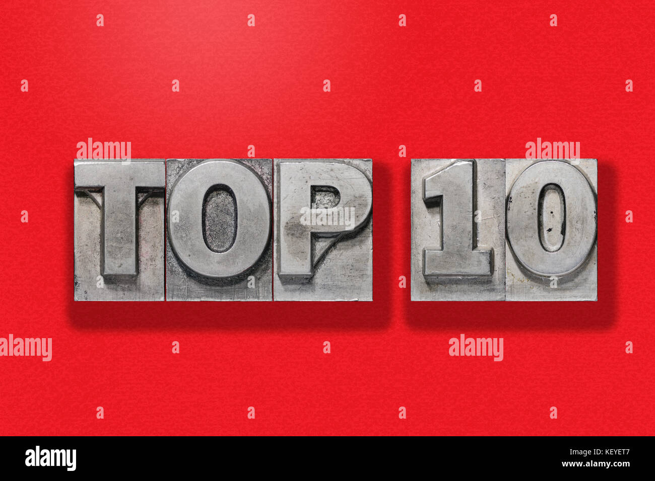 top ten metallic letterpress numbers assembled on red textured ...