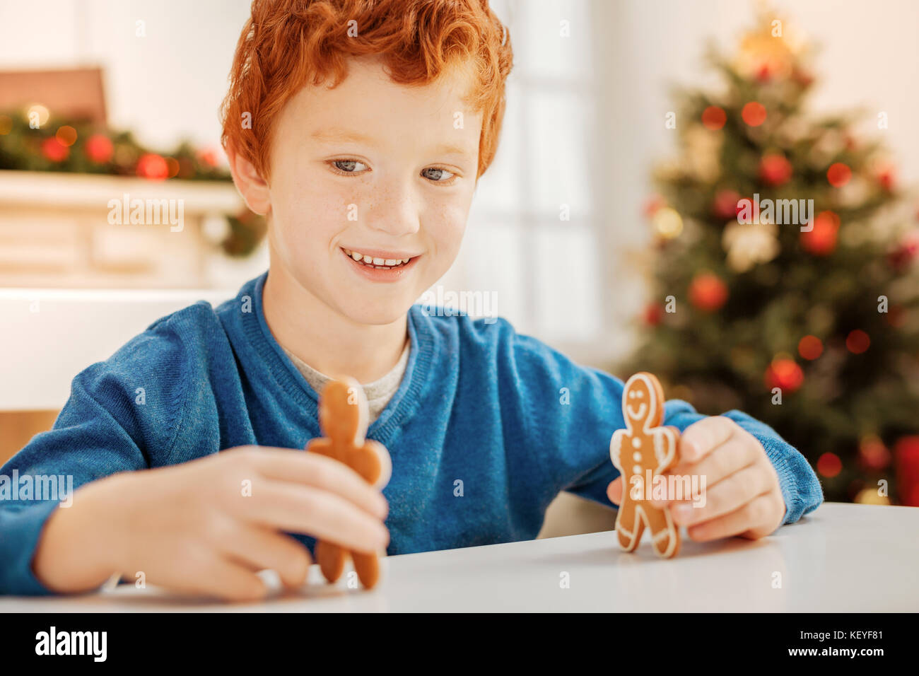 Adorable child smiling while playing with homemade cookies Stock Photo ...