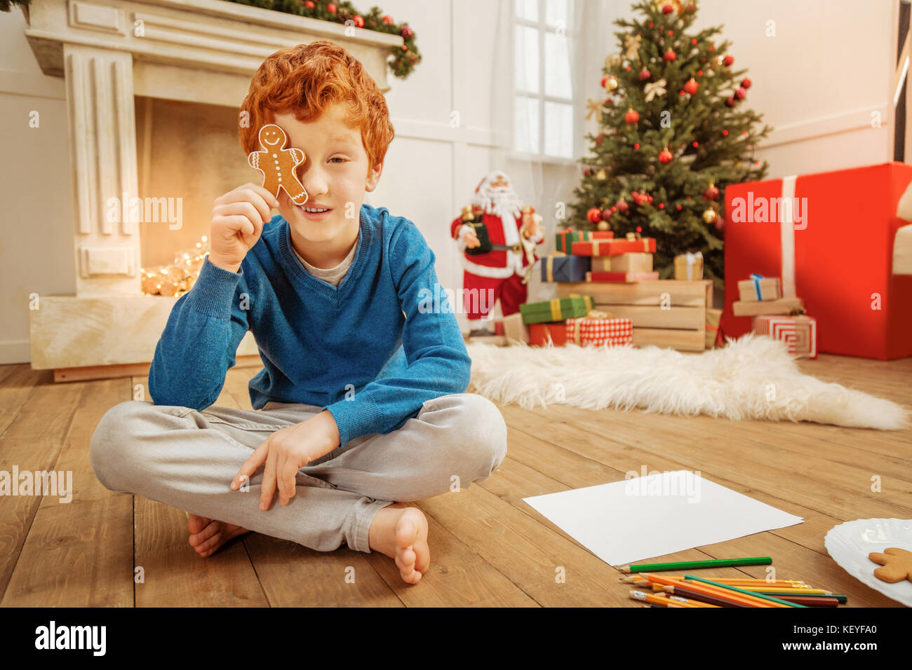Relaxed cute kid playing with gingerbread man at home Stock Photo - Alamy