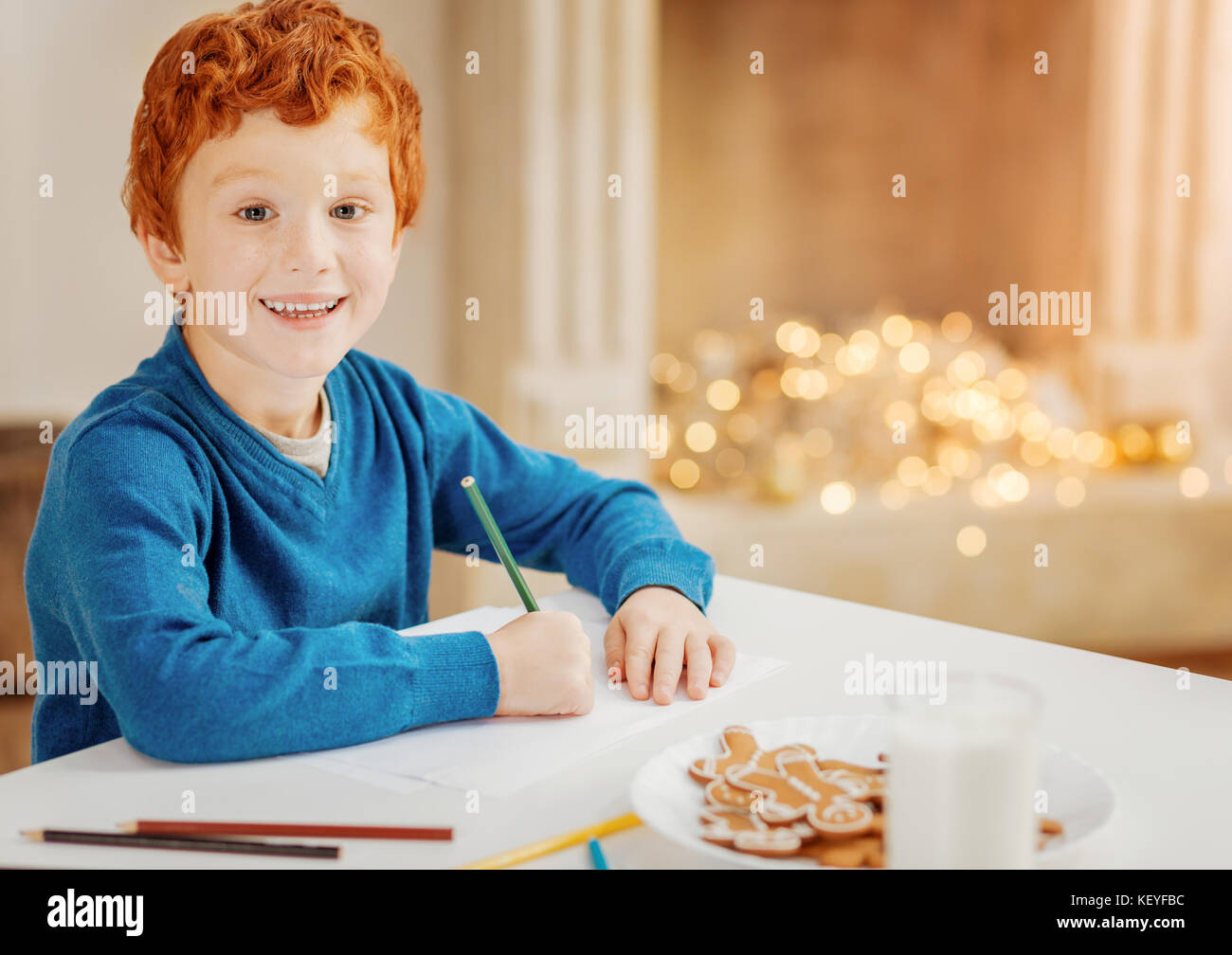 Excited little boy writing letter to santa claus Stock Photo - Alamy