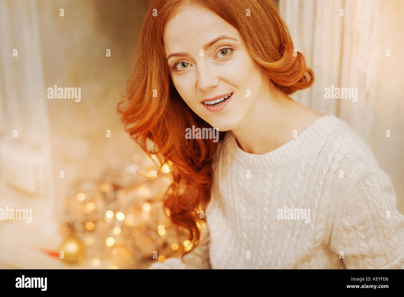 Woman fireplace smile looking at camera hi-res stock photography and ...