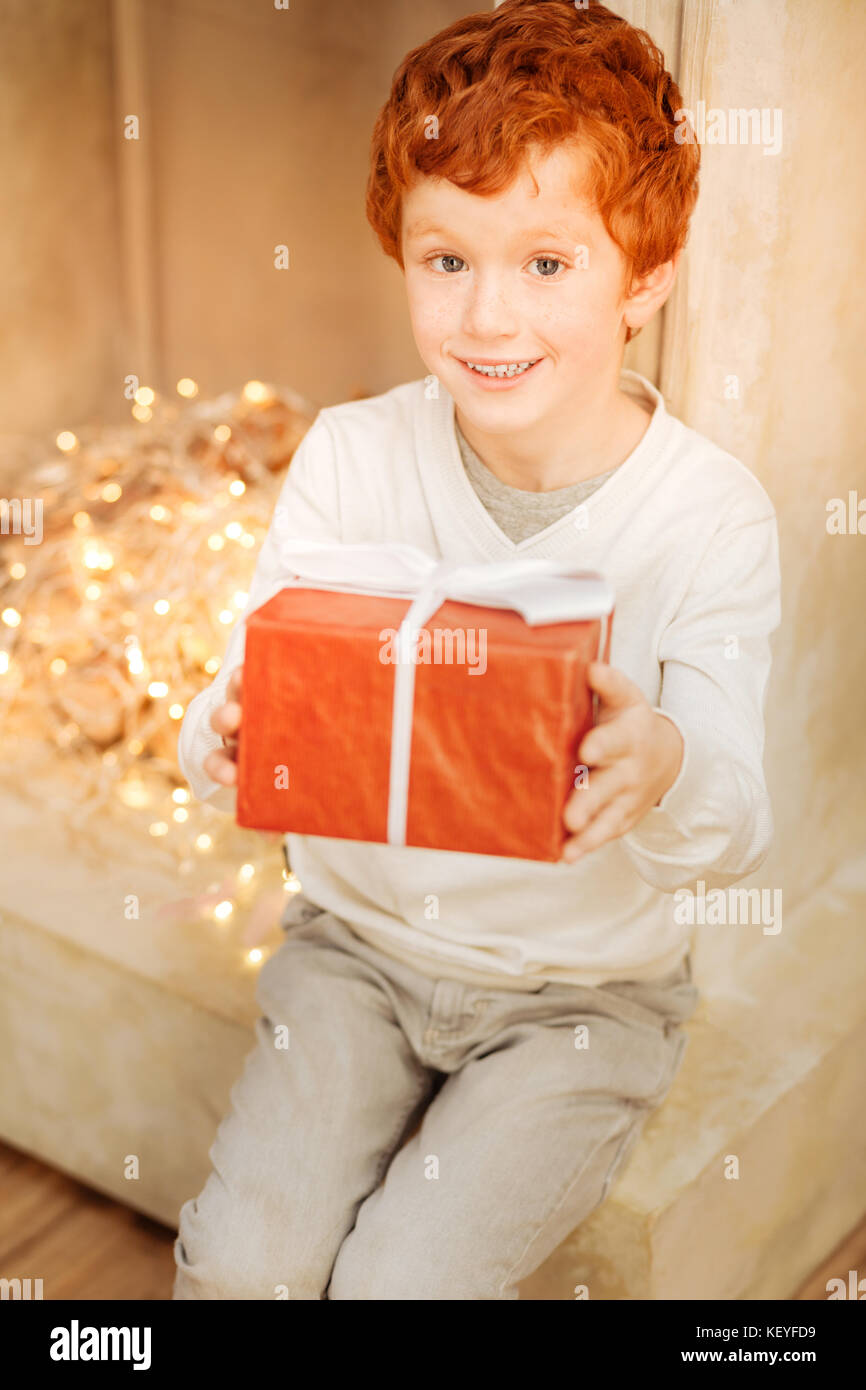 Excited ginger child showing his present Stock Photo - Alamy