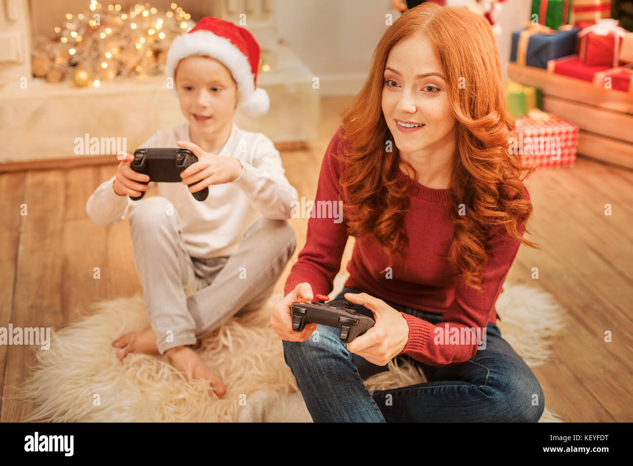 Friendly family playing video games together Stock Photo - Alamy