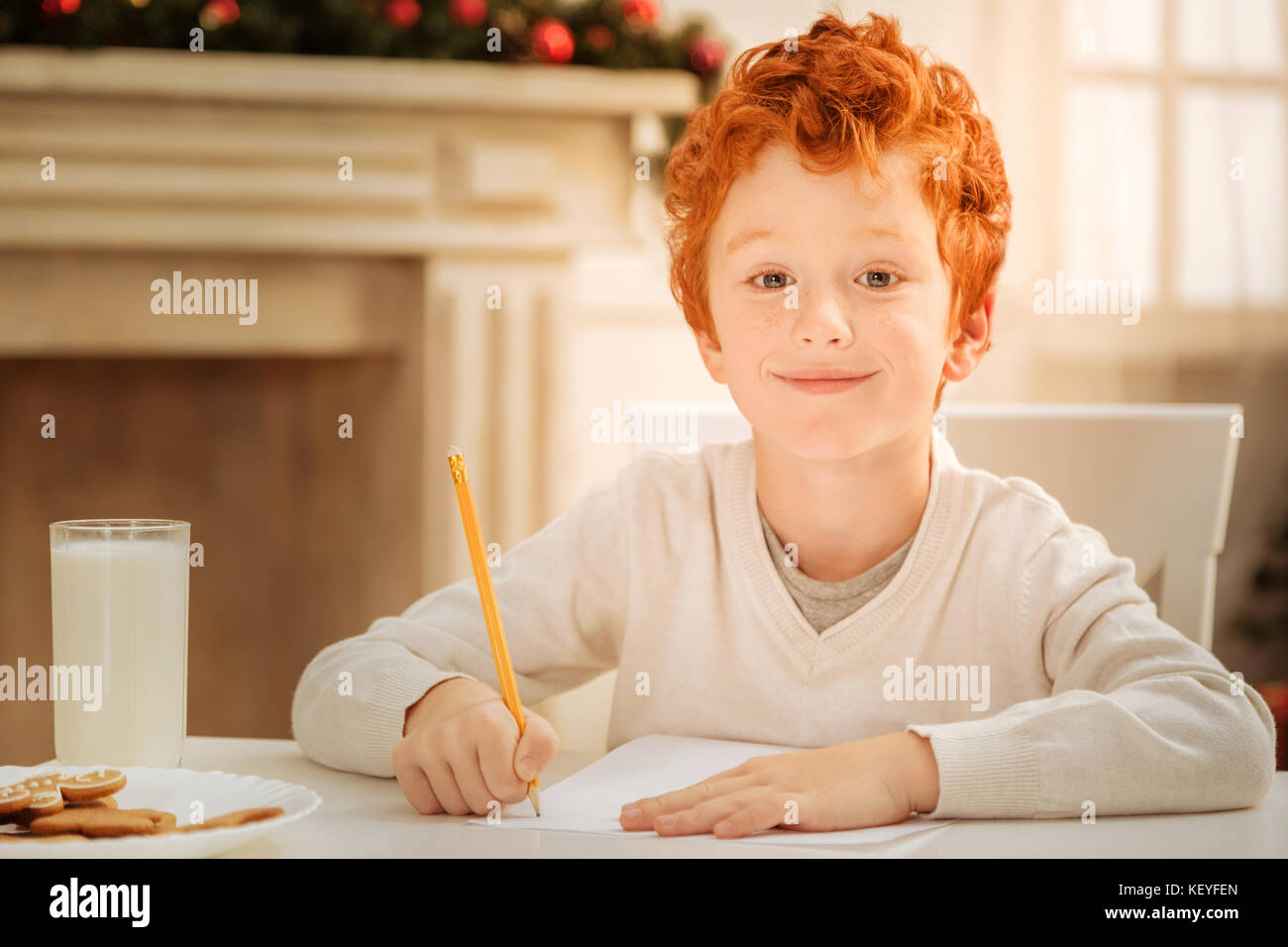 Joyful kid smiling while drawing at home Stock Photo - Alamy