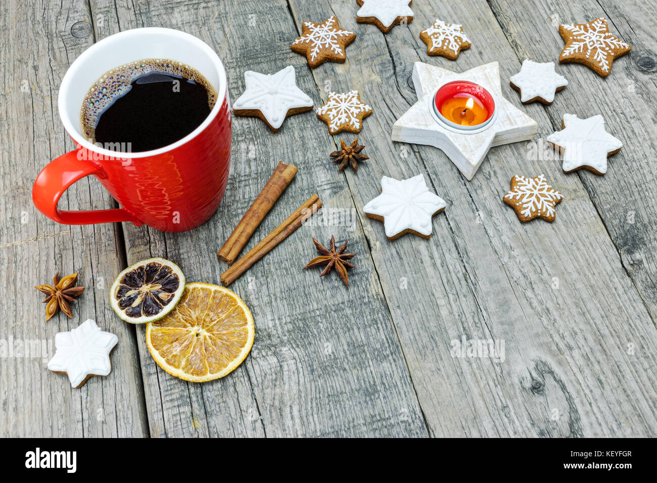 gingerbread star cookies with spiced fruit and cup of coffee on grey ...