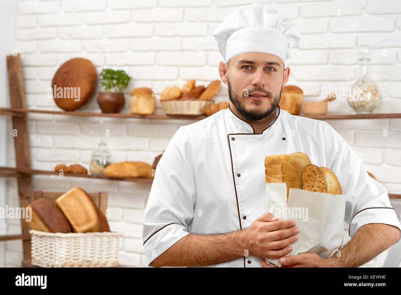 Young man working at his bakery Stock Photo - Alamy