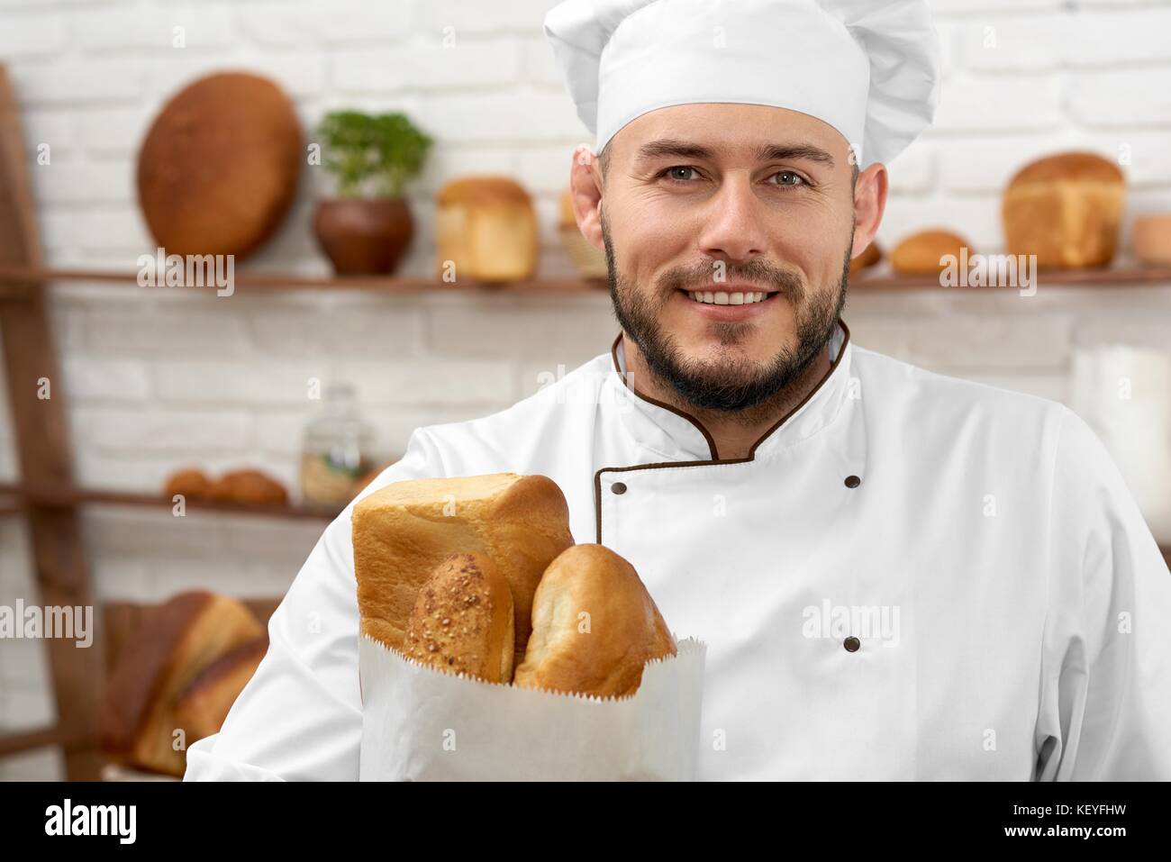 Young man working at his bakery Stock Photo - Alamy