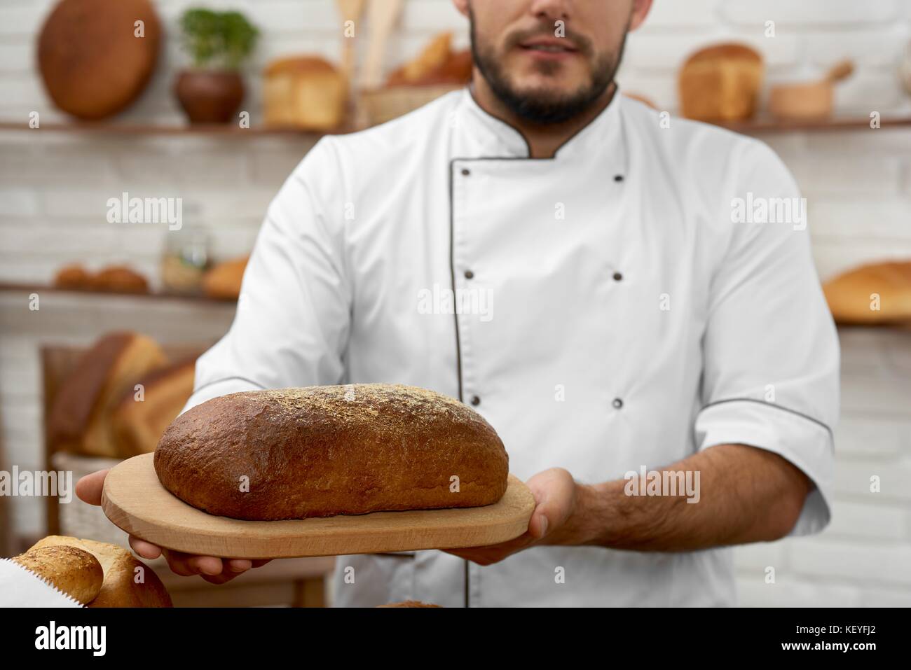 Young man working at his bakery Stock Photo - Alamy
