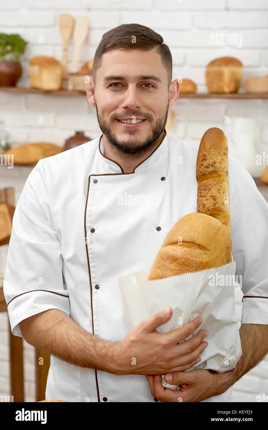 Young man working at his bakery Stock Photo - Alamy