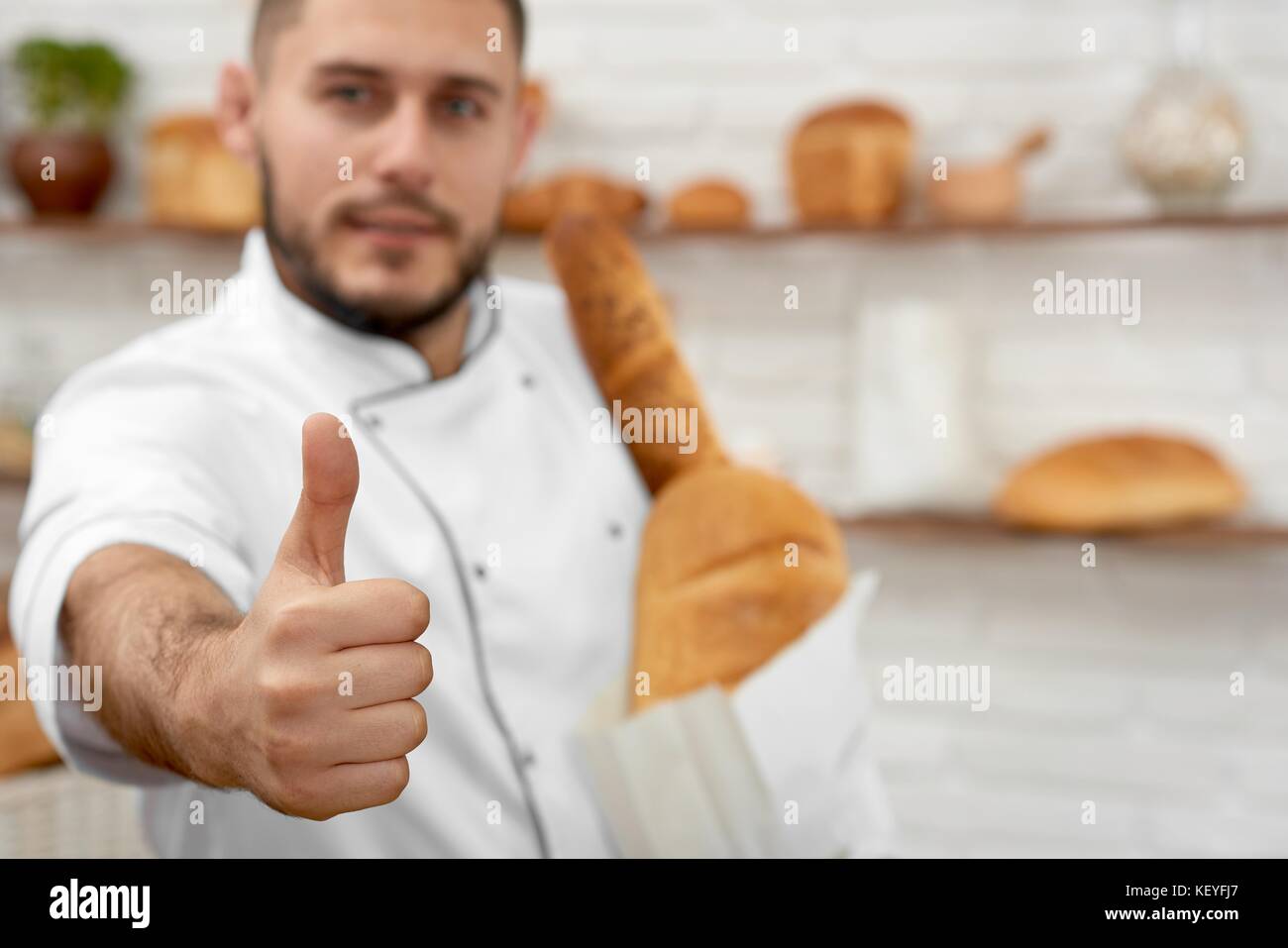 Young man working at his bakery Stock Photo - Alamy