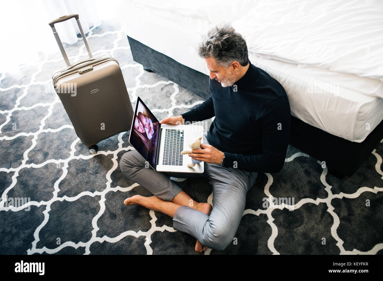 Unrecognizable businessman with laptop in a hotel room. Handsome man ...