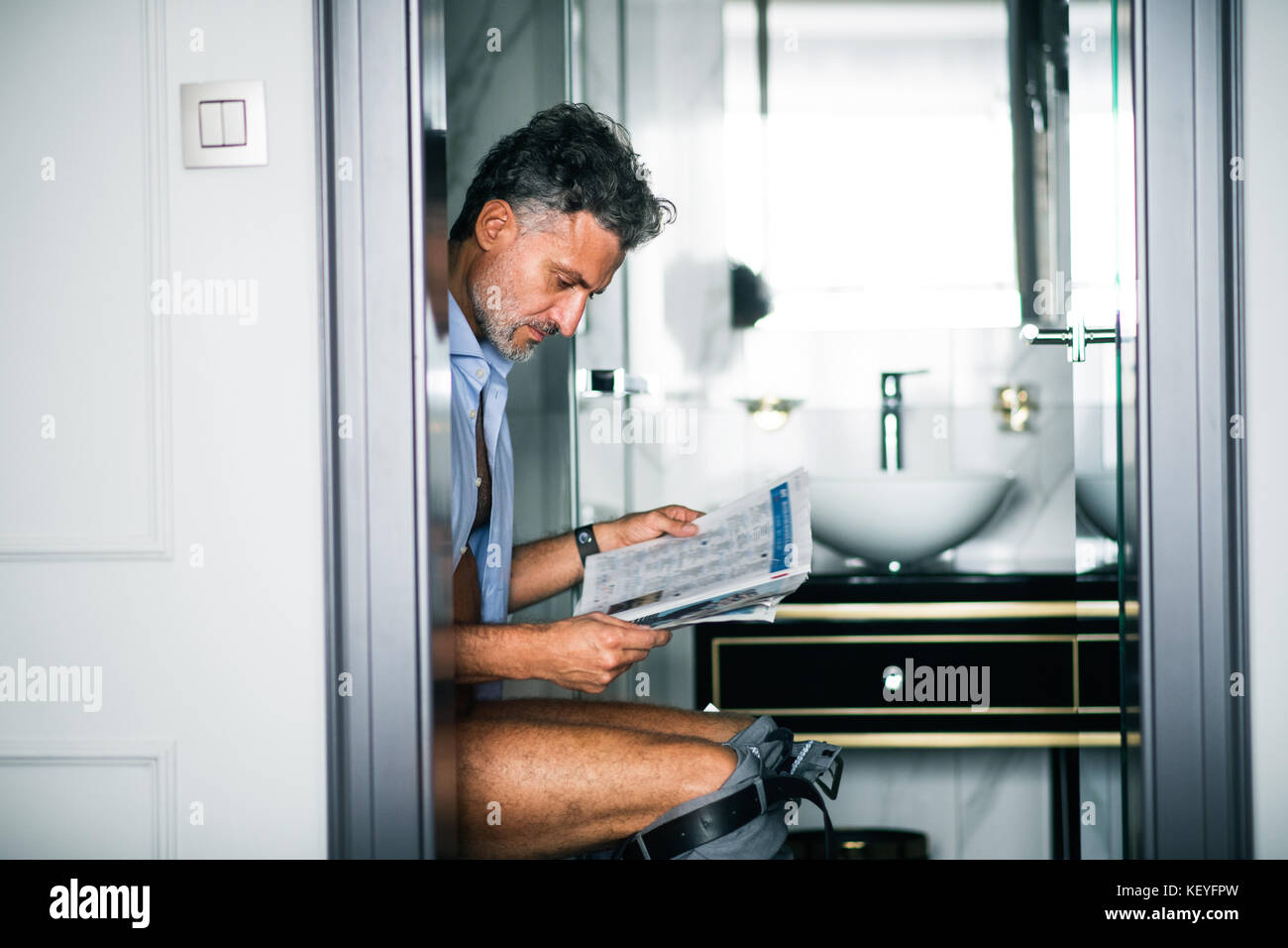 Man sitting toilet hi-res stock photography and images - Alamy