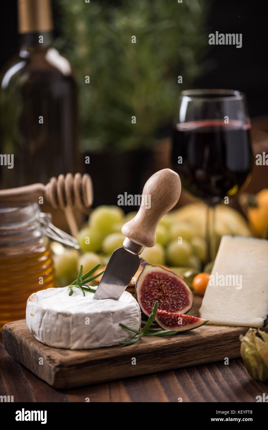 Serving camembert cheese with herbs and fig Stock Photo - Alamy
