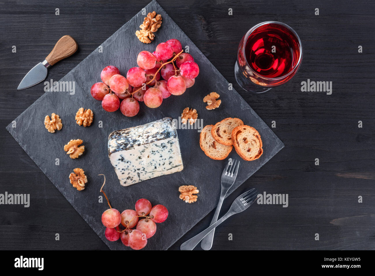 Blue cheese and grapes on black with copy space Stock Photo - Alamy