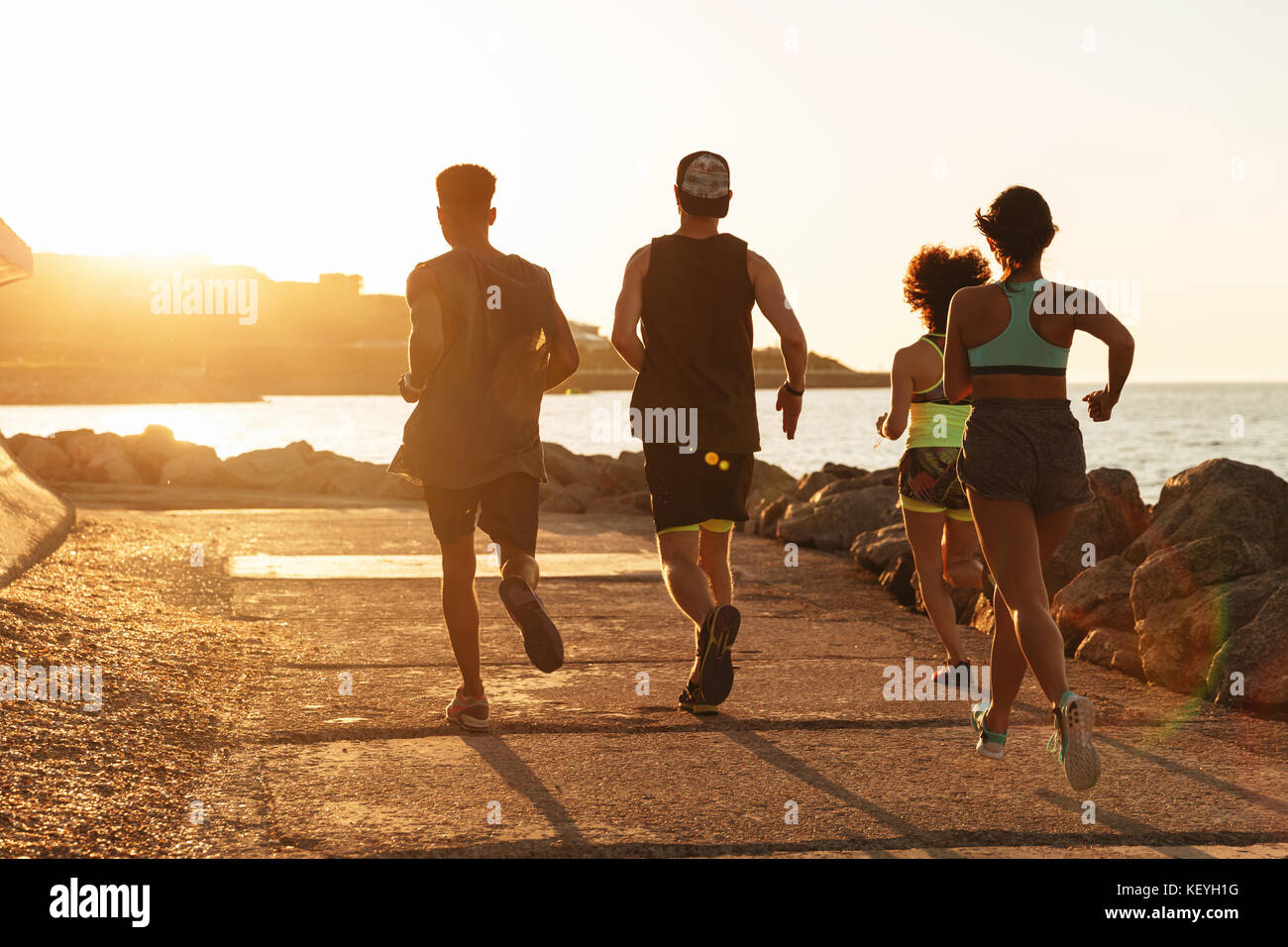 Back view of four friends running hi-res stock photography and images ...