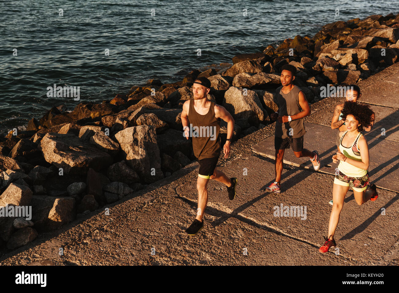 Group of people running seaside sunrise hi-res stock photography and ...