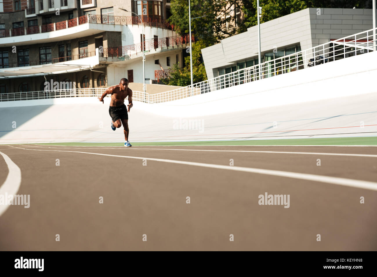 Photo of young african athlete man run on running track outdoors Stock ...