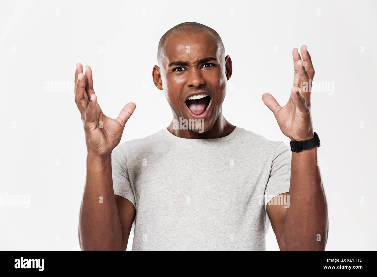 Photo of emotional screaming young african man standing isolated over ...