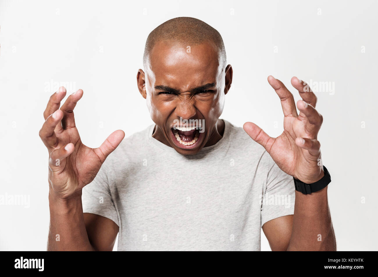 Photo of emotional screaming young african man standing isolated over ...