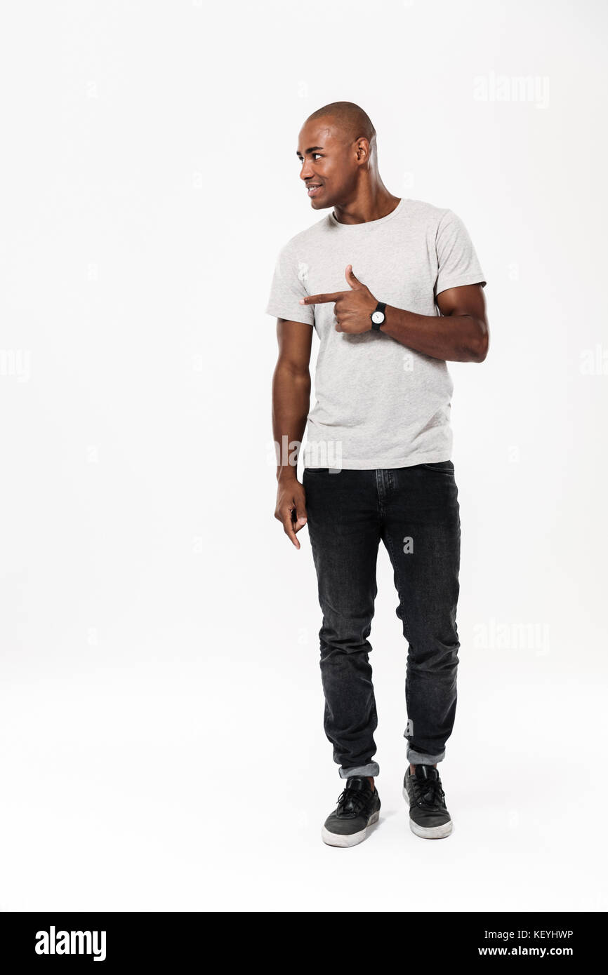 Photo of happy young african man standing isolated over white ...
