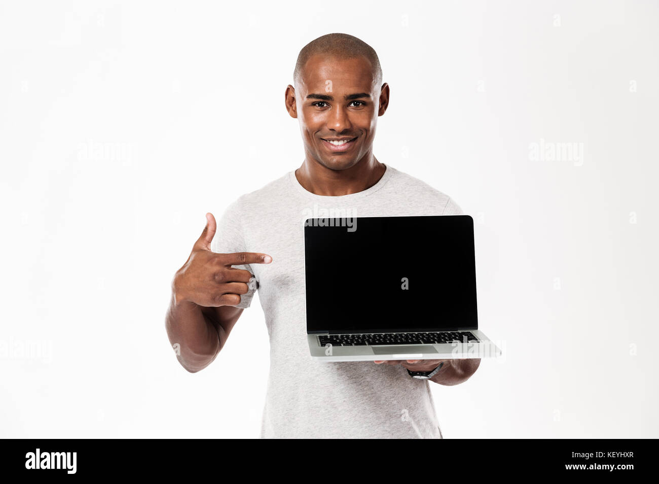 Photo of cheerful young african man standing isolated over white ...