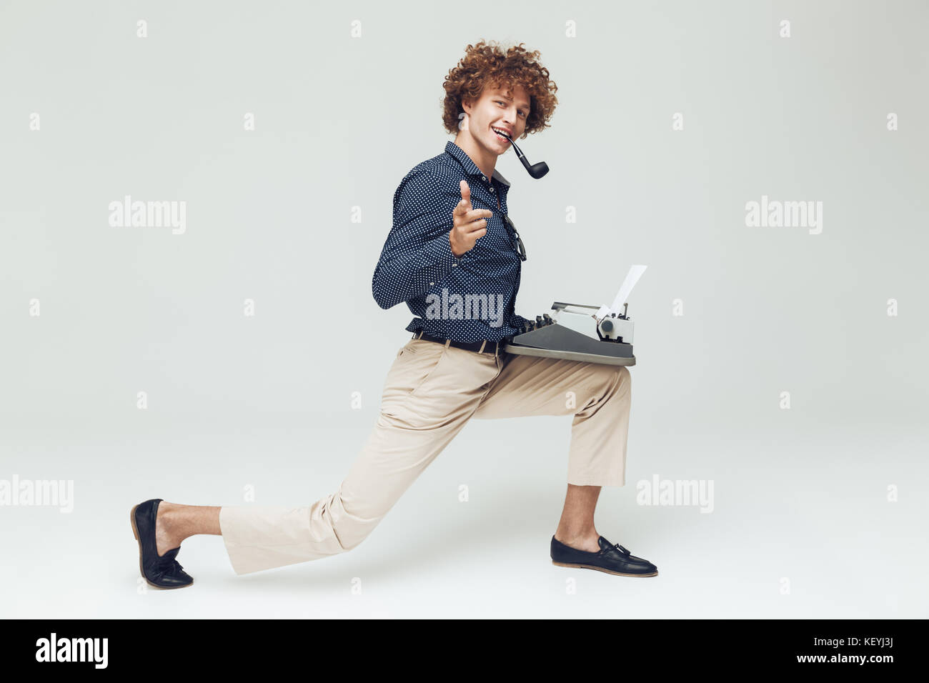 Photo of young happy retro man dressed in shirt sitting and posing ...