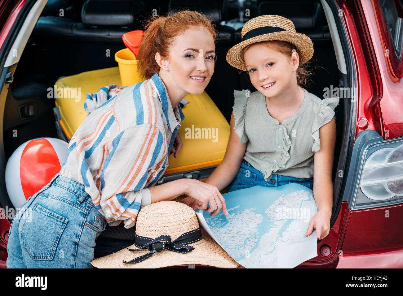 mother and daughter in car trunk Stock Photo - Alamy