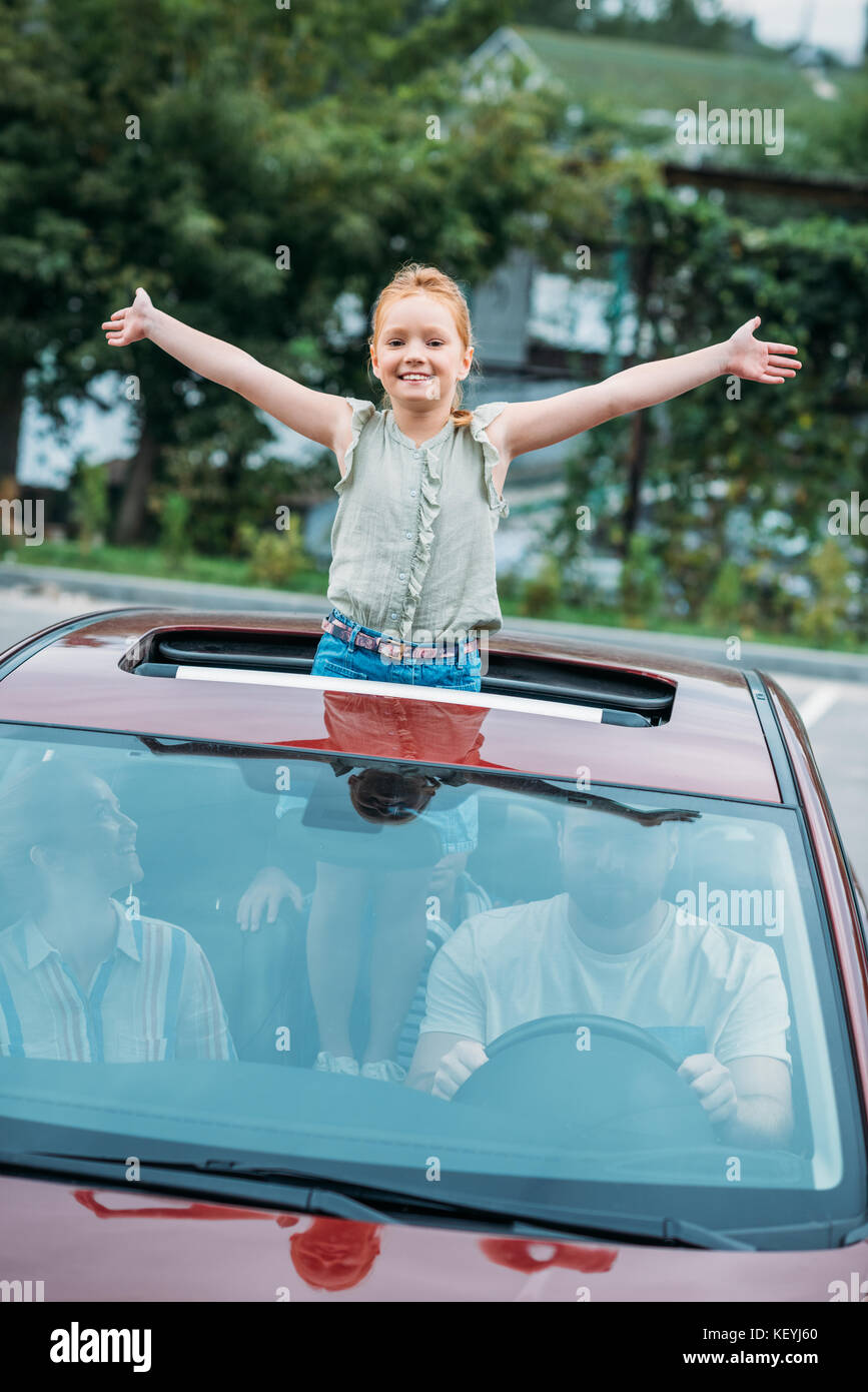girl peering out of sun roof Stock Photo - Alamy