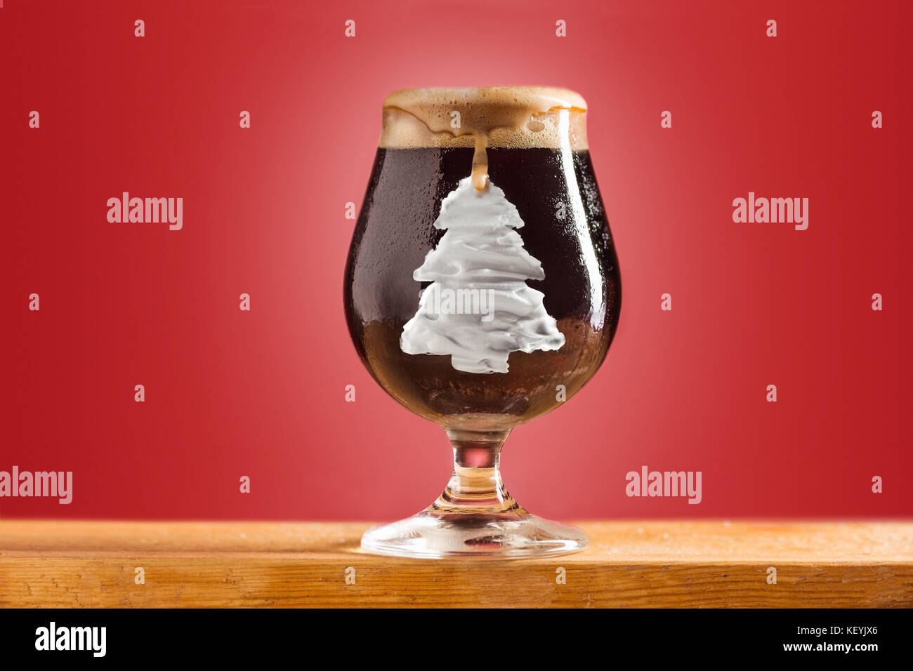 glass of cold frothy dark beer on an old wooden table Stock Photo - Alamy