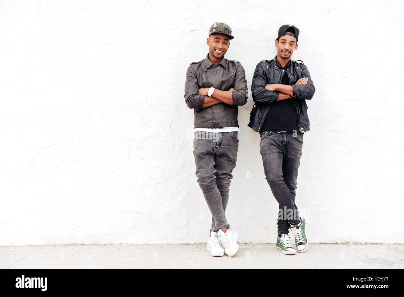 Picture of happy two young african men friends standing outdoors ...