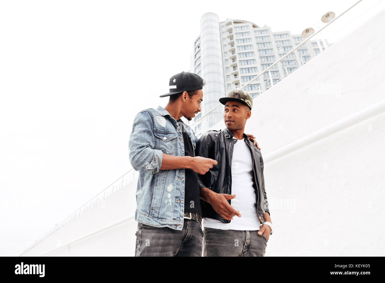 Image of concentrated two young african men friends walking outdoors ...