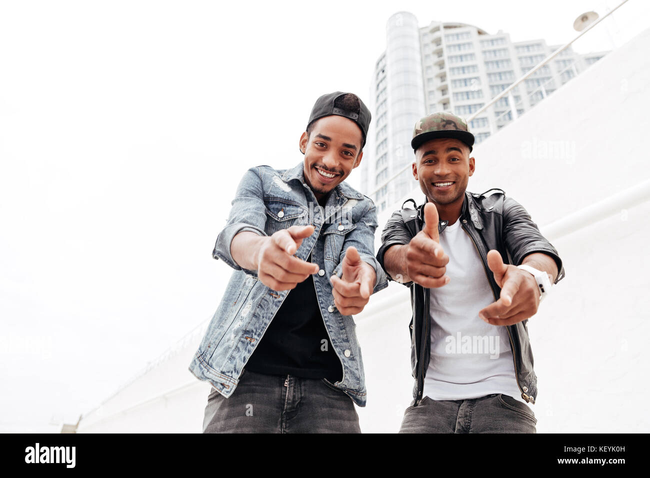 Image of cheerful two young african men friends walking outdoors ...