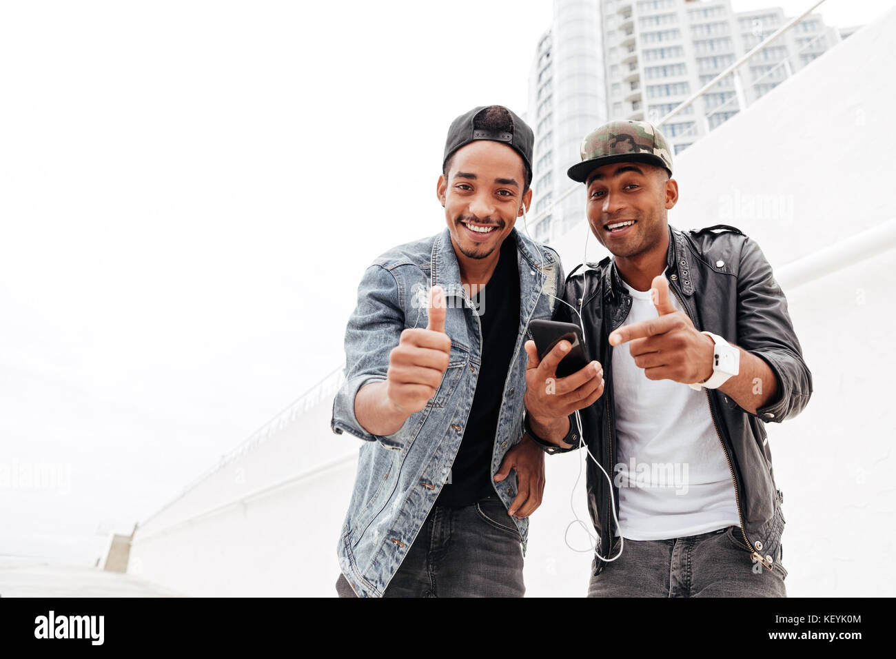 Image of cheerful two young african men friends walking outdoors ...