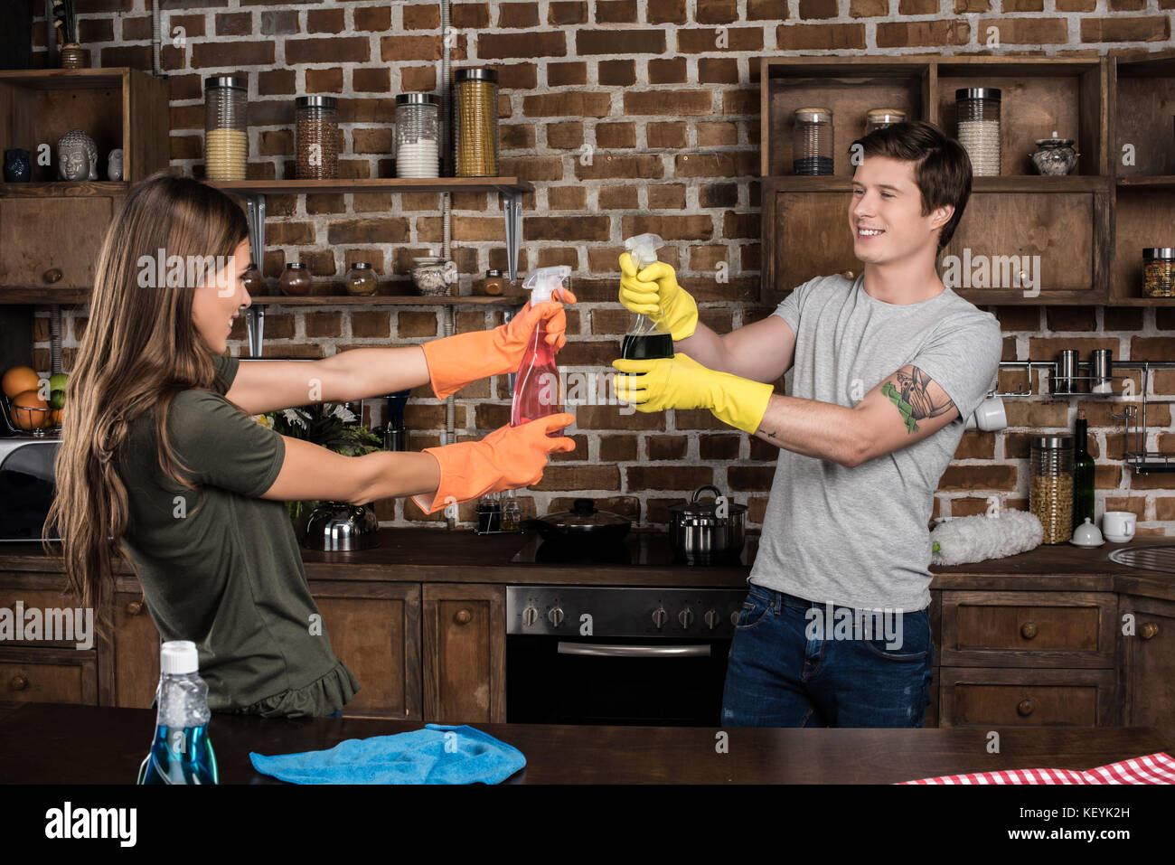 couple having fun while cleaning home Stock Photo - Alamy